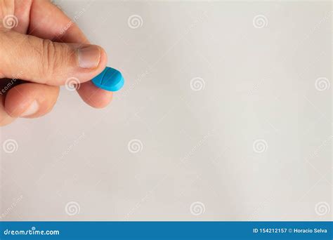 Hand Holding A Color Pill Medicines For Sex And Impotence White Background With Free Space To