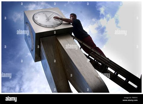 Man Sets To Work On The Running Man Clock In Glasgow Picture Copyright Chris Watt Tel 07887