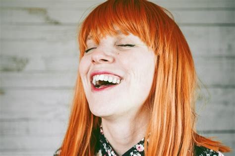 Premium Photo Redhead Woman Laughing Against Wall