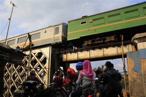 Queue Of Vehicles That Want To Cross Waiting For The Train To Pass