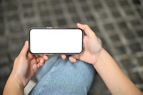 Premium Photo A Female Using Her Smartphone Mobile Phone White Screen Mockup In A Horizontal