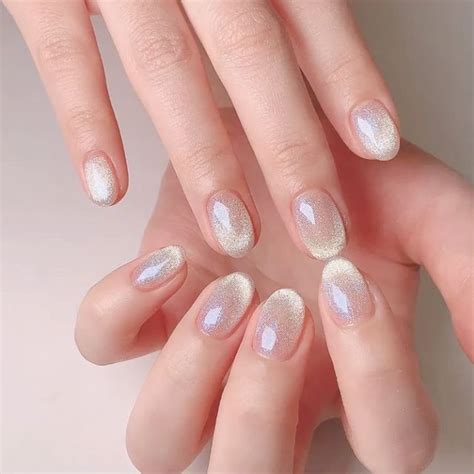 A Womans Hands With White And Silver Manies