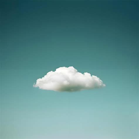 Premium Photo A Single Cloud Floating In A Blue Sky