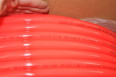 Radiant Floor Heating Orange Frisbee And Red Plastic Hoses