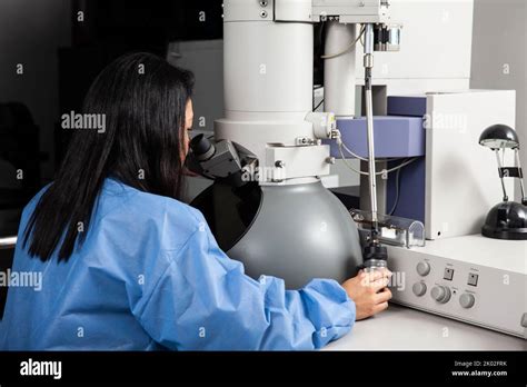 Young Female Scientist Working At The Laboratory With An Electron Young Female Scientist Working At The Laboratory With An Electron