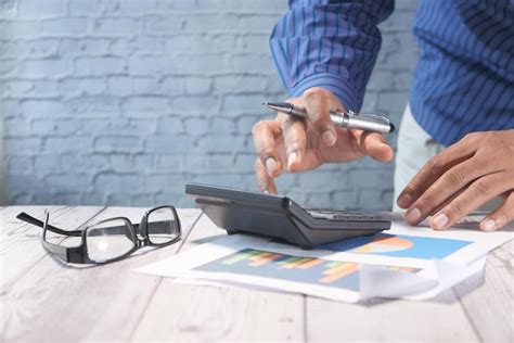 Premium Photo Close Up Of Man Hand Using Calculator