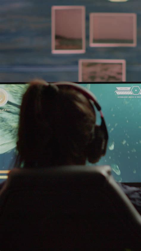 Vertical Upset Professional Woman Gamer Wearing Headset Losing Space Shooter Game In