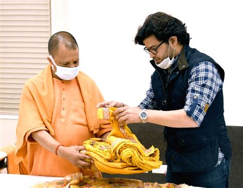 Free Photo Designer Manish Tripathi With Yogi Showing Him New Clothes