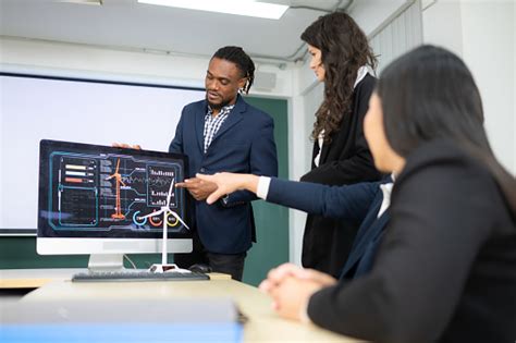 사업가와 엔지니어로 구성된 다양한 팀이 사무실에서 풍력 에너지를 전기로 변환하는 풍력 터빈 엔지니어링에 대해 상담합니다 개발에