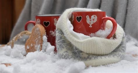 Premium Photo Two Red Mugs With Heart Shaped And One In A Woolen Hat