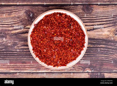Dried Red Pepper Flakes Spice Chili Pepper Flakes On Wood Background