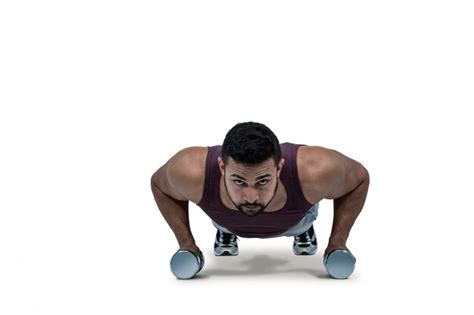 Premium Photo Muscular Man Doing Push Ups With Dumbbells