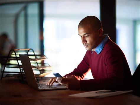 Premium Photo Keeping In Touch Via Text Shot Of A Handsome Young Man Sending A Text While