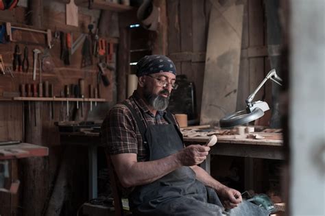 Premium Photo Spoon Master In His Workshop With Wooden Products And