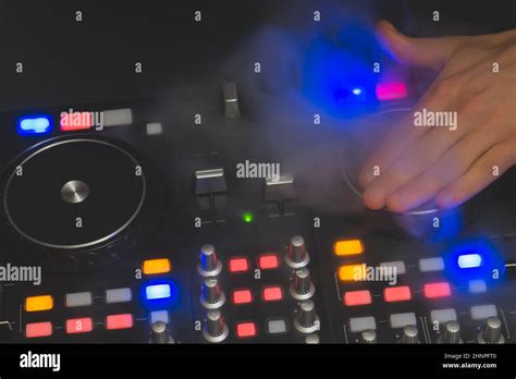 DJ Plays Music Sound Mixer Controller With Knobs And Sliders Close Up Hands On The Mixing Deck