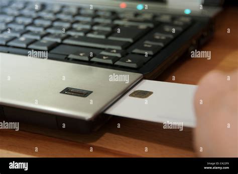 Computer Access Card Being Slotted Into Card Reader Built Into Laptop Stock Photo Alamy