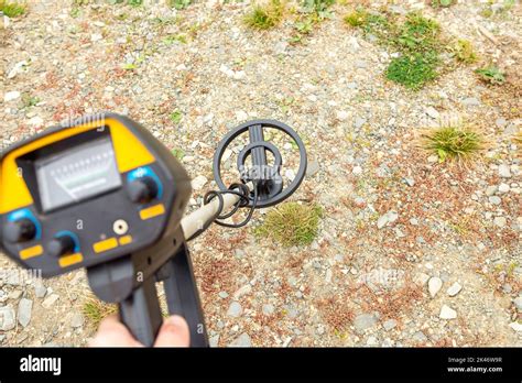A Man With A Metal Detector On The Shore Of A Reservoir Metal Searches In The Coastal Zone