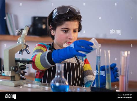 A Funny Young Nerd In A Home Research Laboratory Wearing Safety Glasses