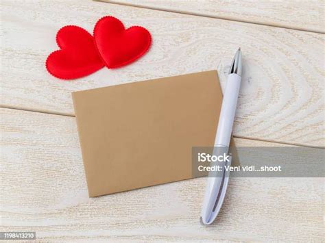 갈색 종이 빈 인사말 카드 흰색 볼펜과 흰색 나무 질감 배경에 두 개의 빨간 실크 발렌타인 하트 개념 사랑 발렌타인 데이 공간을 복사합니다 0명에 대한 스톡 사진 및 기타