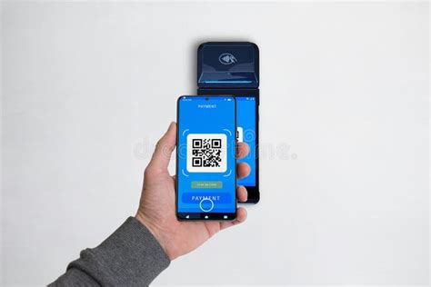 Smartphone Scanning A Qr Code On A Pos Terminal To Complete A Payment Highlighting An