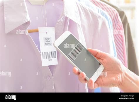 Woman Scanning Barcode From A Label In A Shop With Mobile Phone Stock Photo Alamy