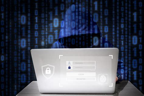 Dangerous Hooded Hacker Typing Bad Data Into Computer Online System And