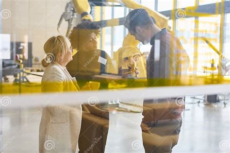 Engineers Discussing Robotics And Automation Technology In Modern