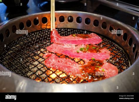 Close Up Raw Beef Slice On The Grill Over Charcoal On Stovejapanese