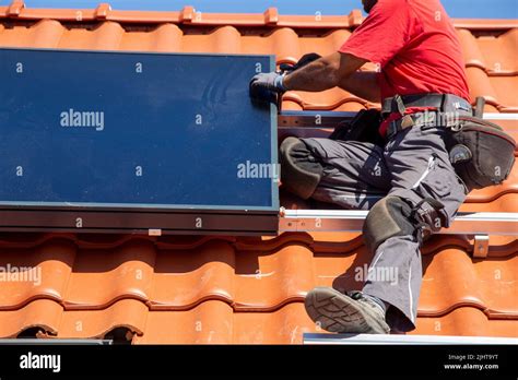 Installation Of A Solar System Craftsmen Attach The Solar Panels Stock Photo Alamy