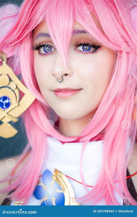 Female Cosplayer In A Pink Anime Costume Wearing Pink Hair Stock Image