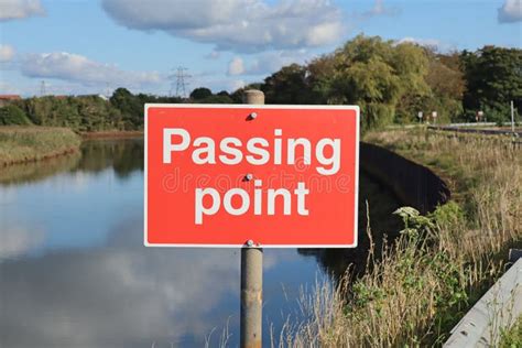 A Red Passing Point Sign By The Side Of The River Exe Near Exeter In