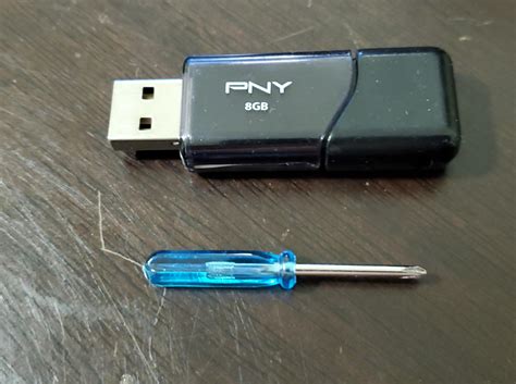 The Tiny Phillips Head Screwdriver Compared To A Flash Drive R