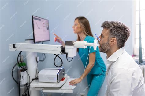 Premium Photo Man Performing Pulmonary Function Test And Spirometry Using Spirometer At