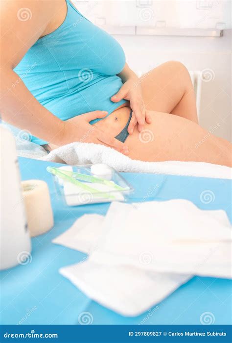 Woman Touching Wound And Stitches Showing Recovery Healing Measures With Aid Kit Stock Image