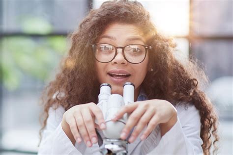 Premium Photo Attractive Female Scientist Looking Through A Microscope