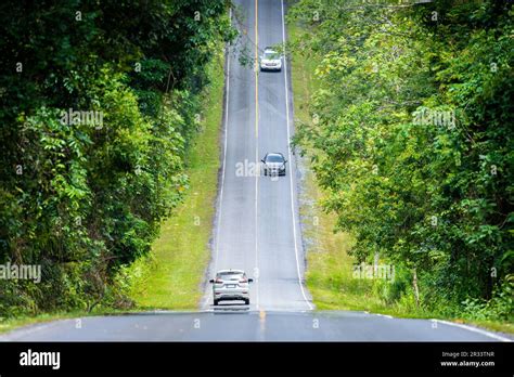 Driving Cars On Straight Road In Countryside On Hill Slope Surrounding