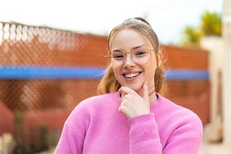 Premium Photo Young Pretty Girl At Outdoors With Happy Expression Premium Photo Young Pretty Girl At Outdoors With Happy Expression