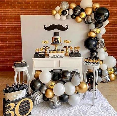 A Table Topped With Balloons And A Cake