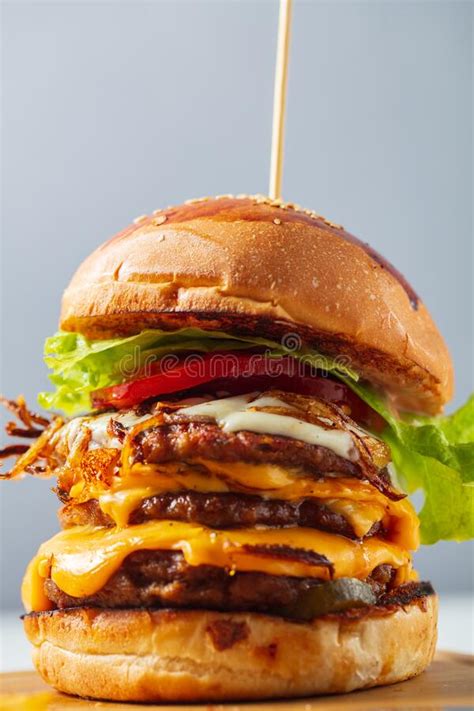 Loaded Cheeseburgers Three Triple Stacked Patties Stacked High With Layers Of Cheese Lettuce