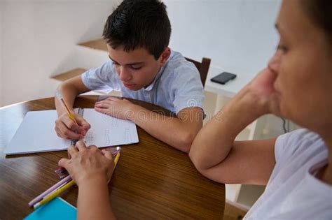 Mother Helping Son With Homework At Home Study Table Stock Photo Image Of Development