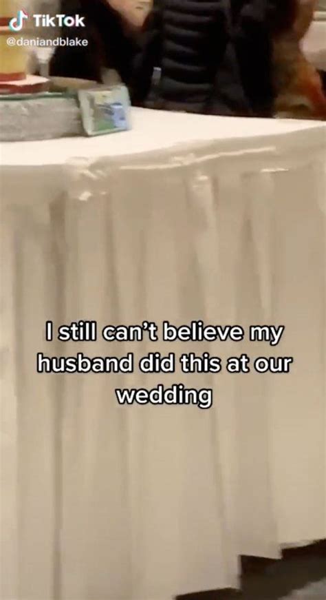A Man And Woman Sitting At A Table In Front Of A Cake With The Words I