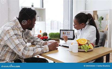 Dietitian Analyzing Data On Tablet With Patient In Clinic Stock Video Video Of Consultation