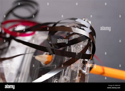 Audio Cassette And Pencil On A Black Table Old Magnetic Data Carrier
