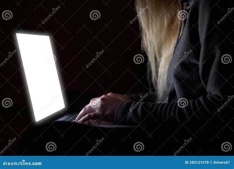 Overhead Hacker In The Hood Working With Laptop Typing Text In The