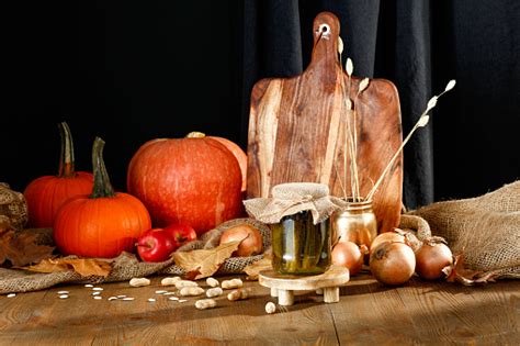 신선한 호박과 사과 과일과 양파가 있는 테이블 배경의 가을 구성 나무 도마와 음식과 제품을 위한 공간이 있는 바구니 가을의 보존 식품과 제철 절임 야채 가을에 대한 스톡