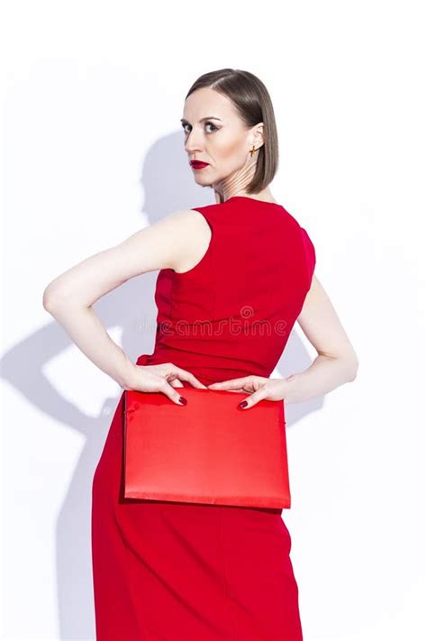 Concentrated Confident Caucasian Business Woman In Red Dress Posing In
