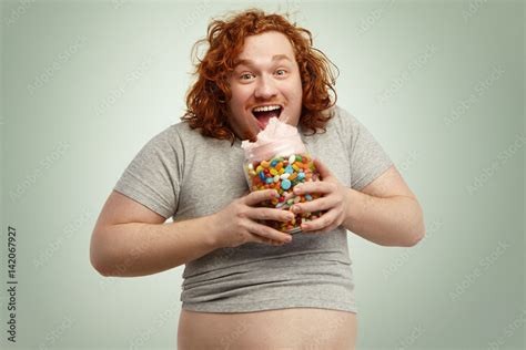 Excited Happy Obese Young Man With Ginger Curly Hair Opening Mouth