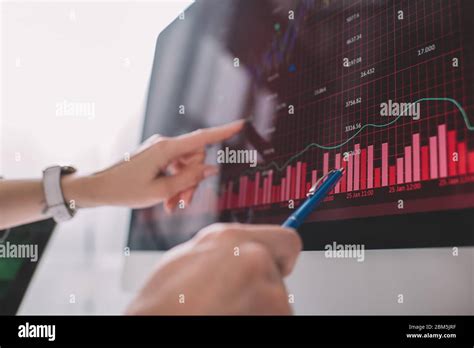 Selective Focus Of Data Analysts Pointing On Graphs On Computer Monitor