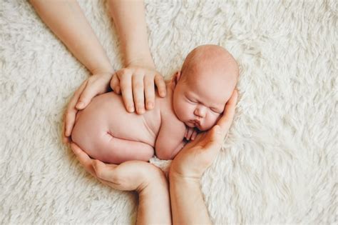Premium Photo Naked Newborn Baby Lying On The Hands Of Parents