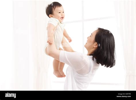 Mother Lifting Her Baby Stock Photo Alamy